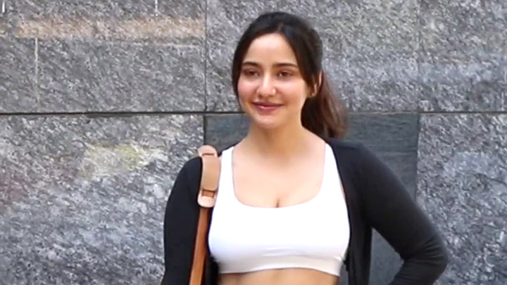 Neha Sharma flaunts her toned midriff as she poses outside her gym ...