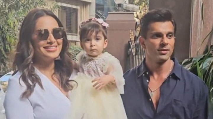 Baby Devi looks amused as she poses for paps with mumma-papa, Bipasha ...